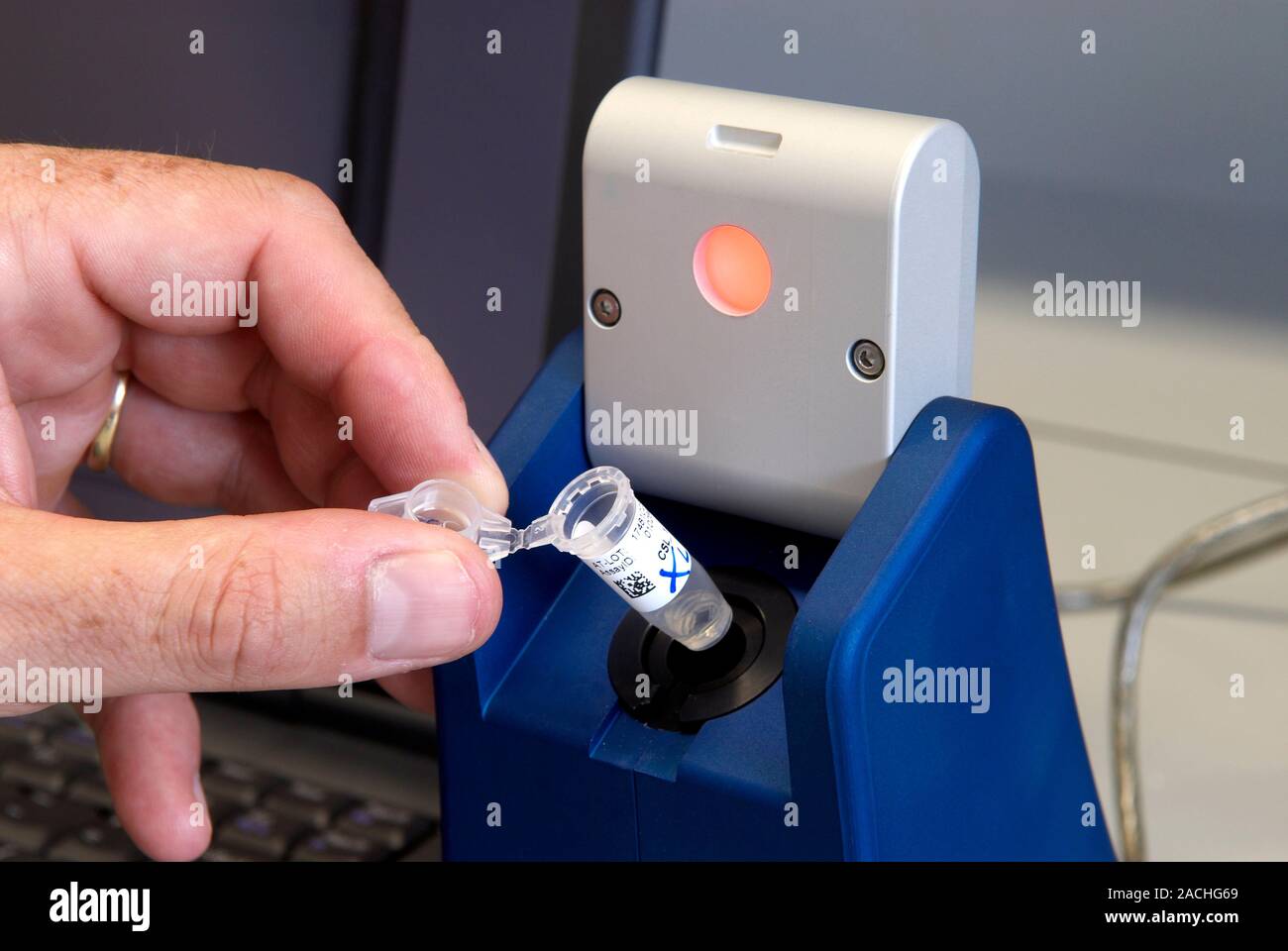 Array tube reader. Microarray tube being placed inside an array tube ...