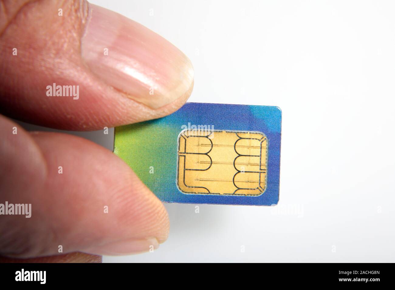 SIM card. Mobile phone subscriber identity module (SIM) card. held ...
