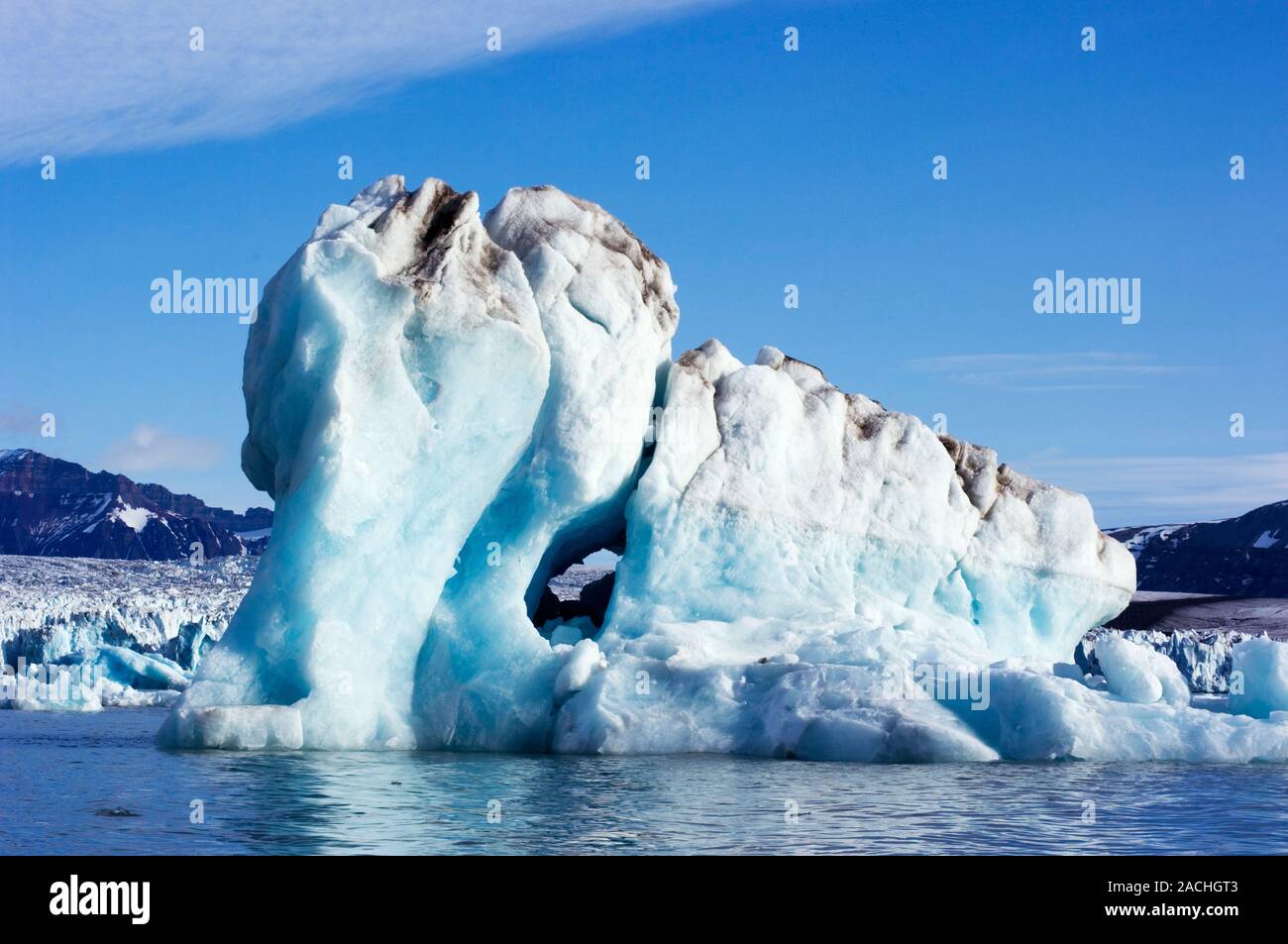 Iceberg. Large iceberg floating in front of a calving glacier. Icebergs ...