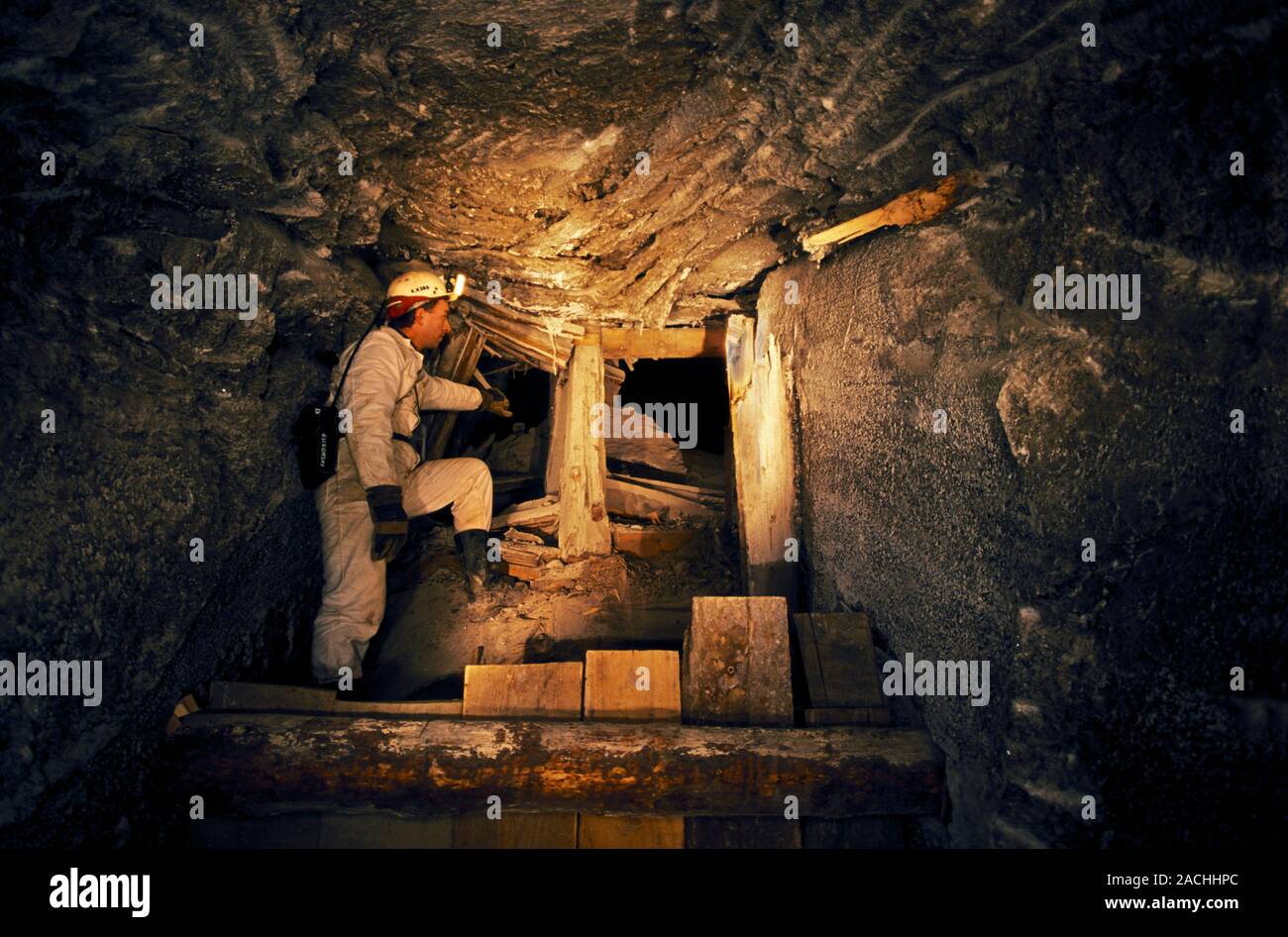 Wooden support beams being inspected by a miner, Wieliczka Salt Mine ...