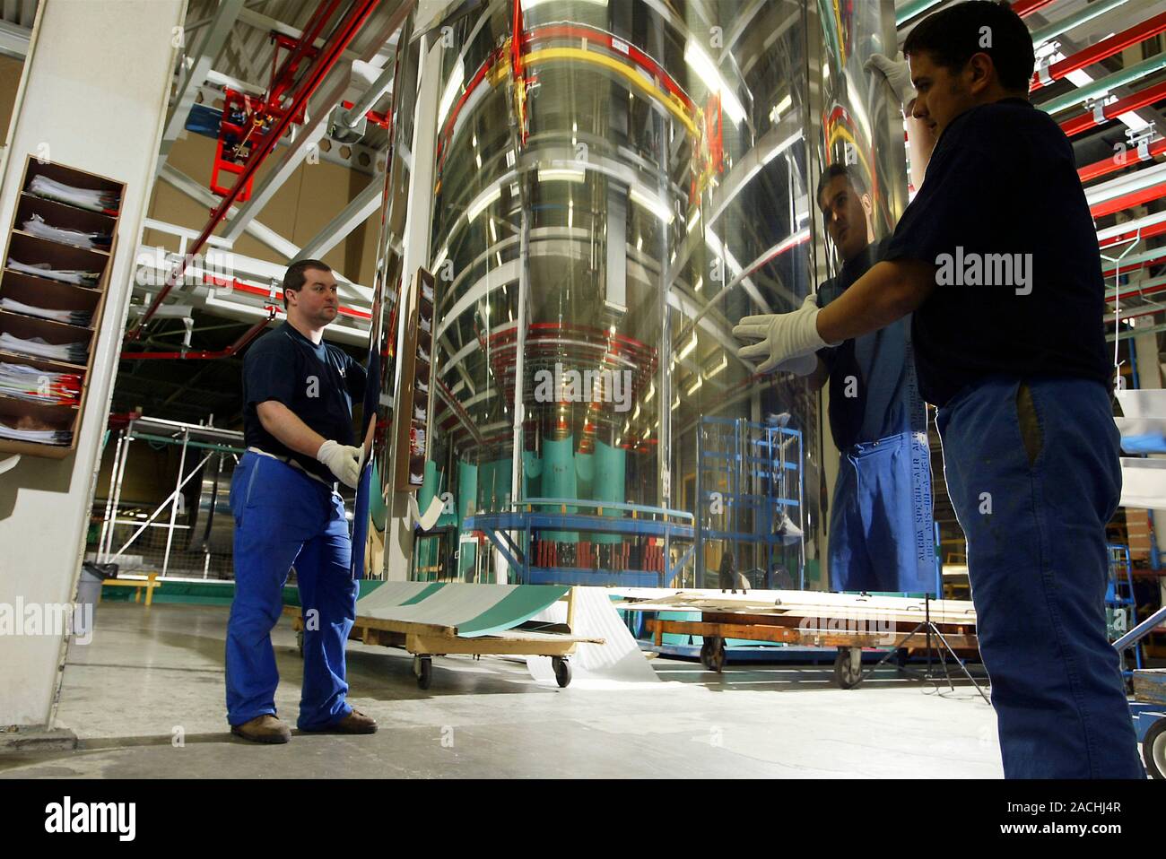 Aeroplane construction. Workers moving parts of an aircraft in an ...