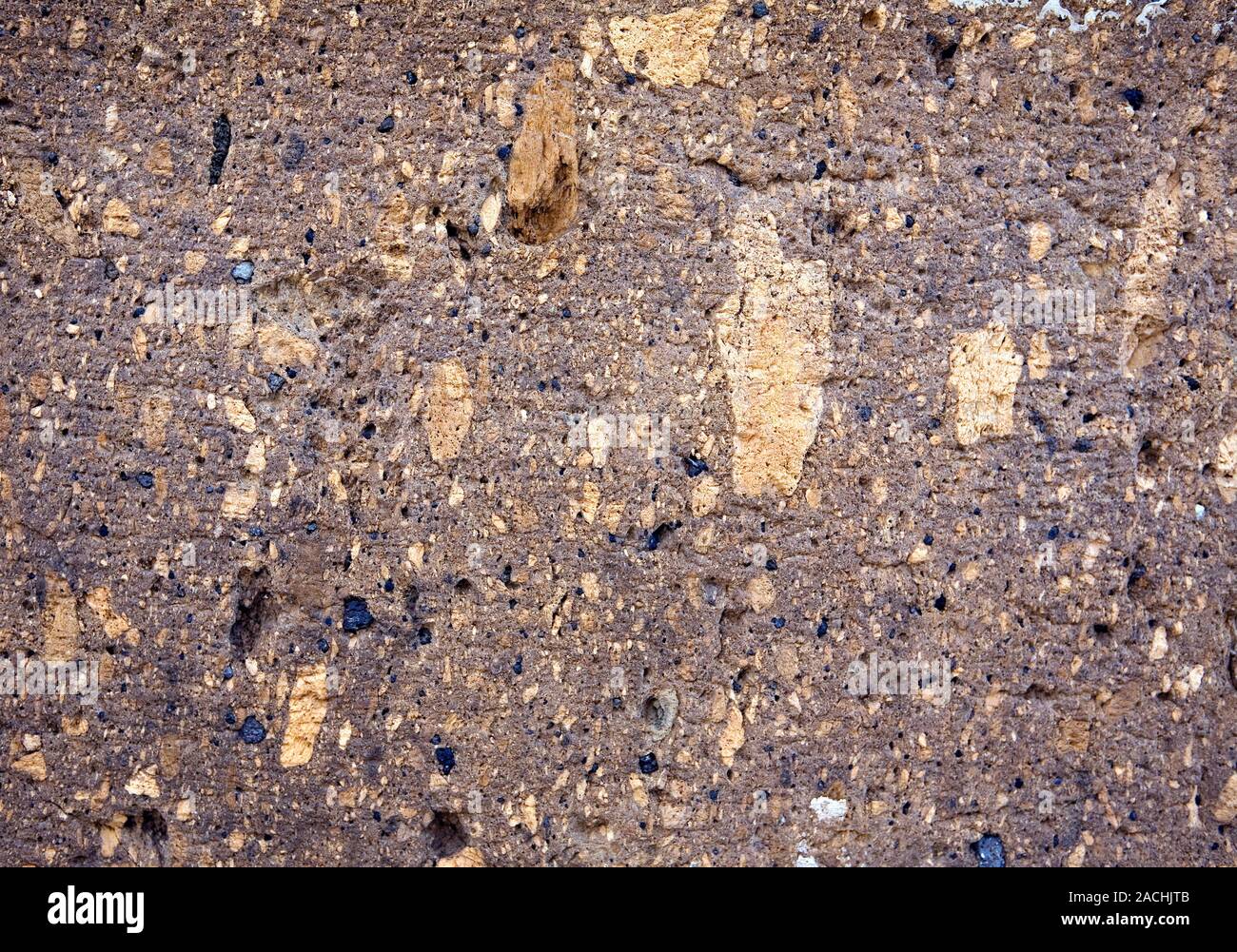 Tuff. Close-up of the surface of a specimen of tuff. Tuff, or tuffstone ...
