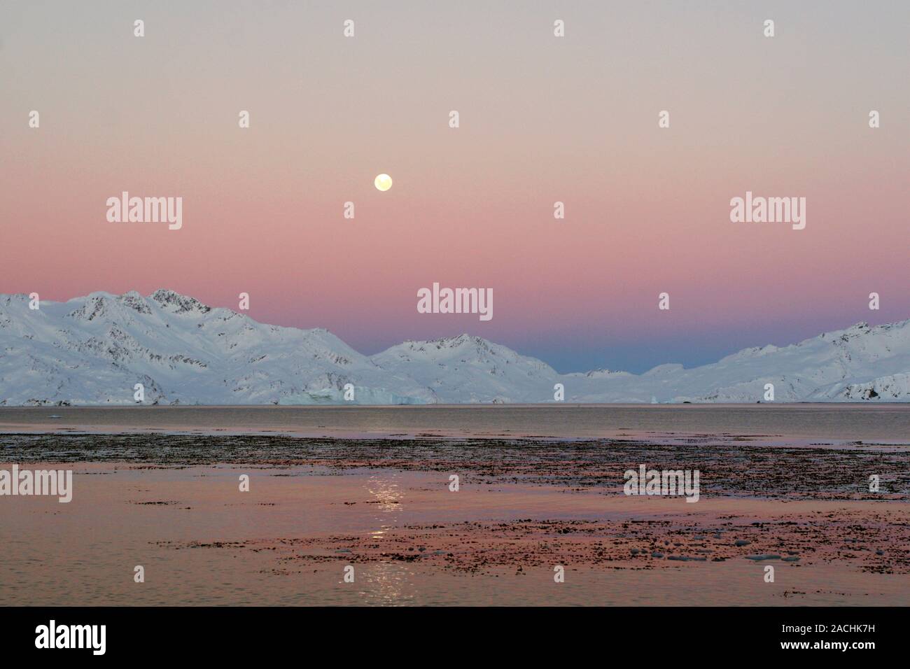 Full Moon over mountains. The Full Moon rises above the horizon soon ...