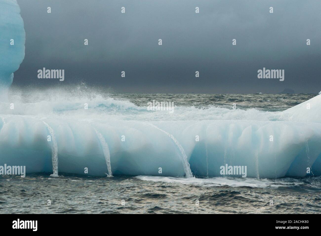 Iceberg. Waves breaking over an iceberg. Icebergs are large chunks of ...