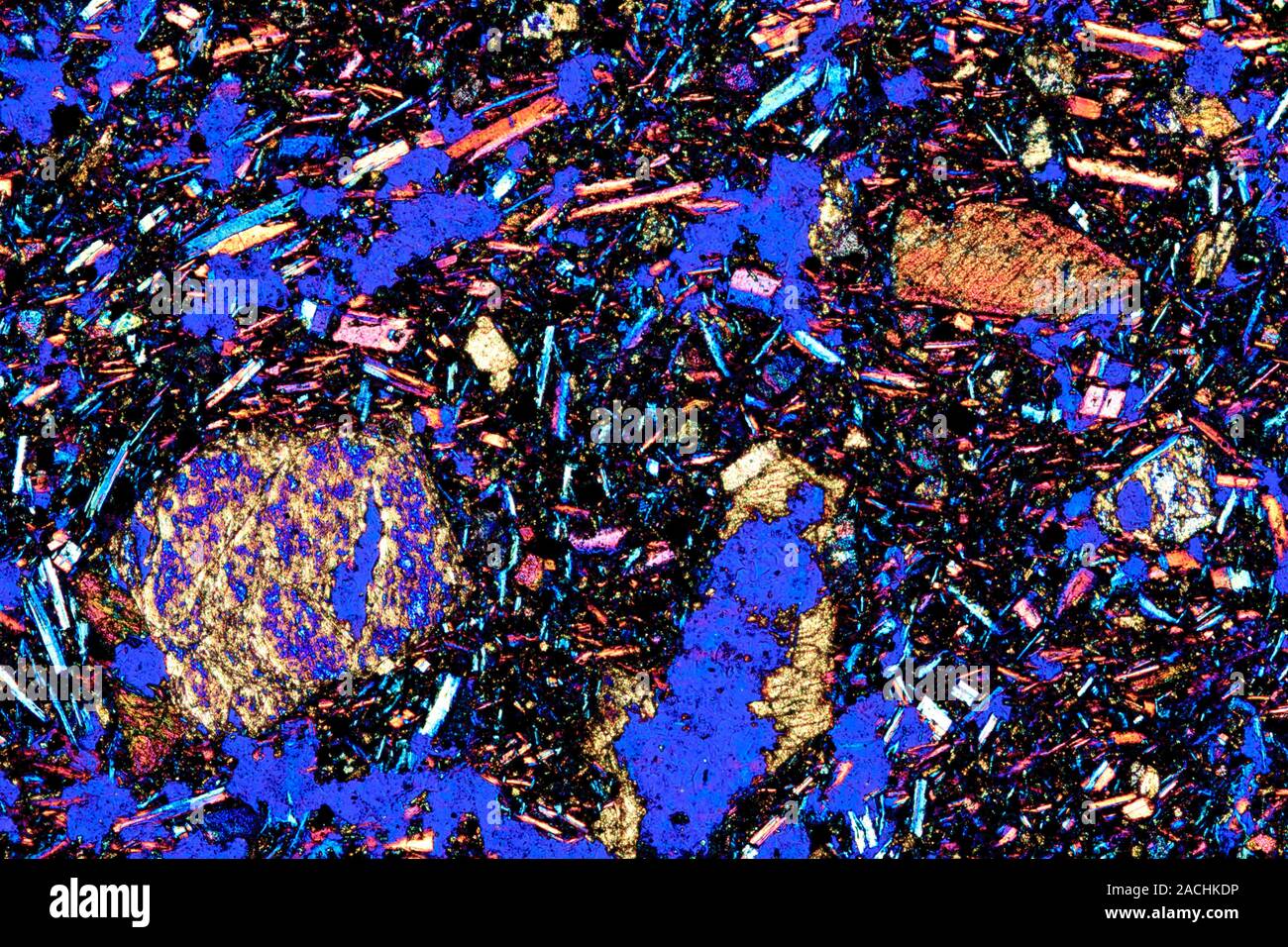 Polarised light micrograph of a thin section of basalt, an igneous rock ...