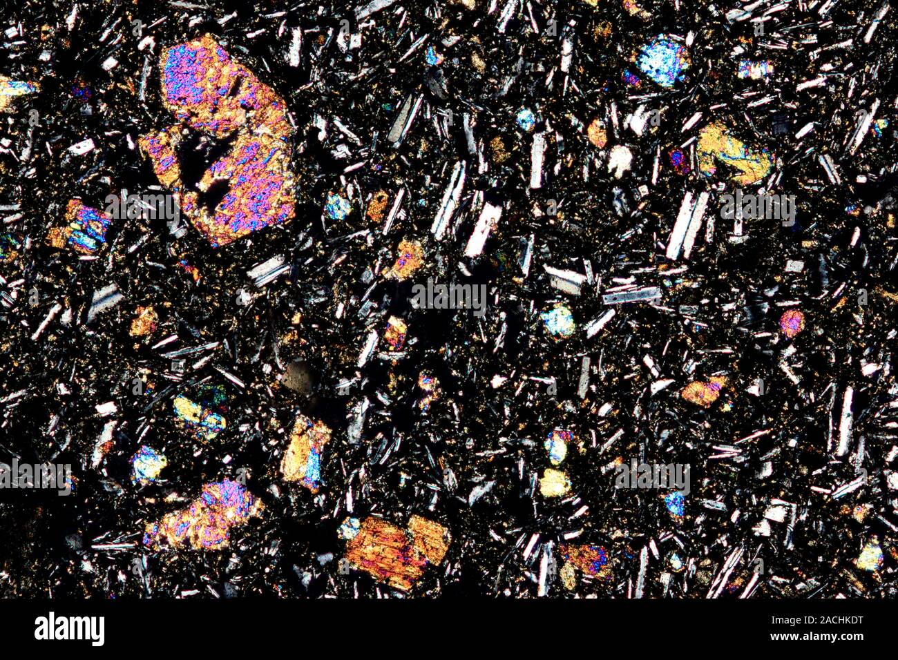 Polarised light micrograph of a thin section of basalt, an igneous rock ...