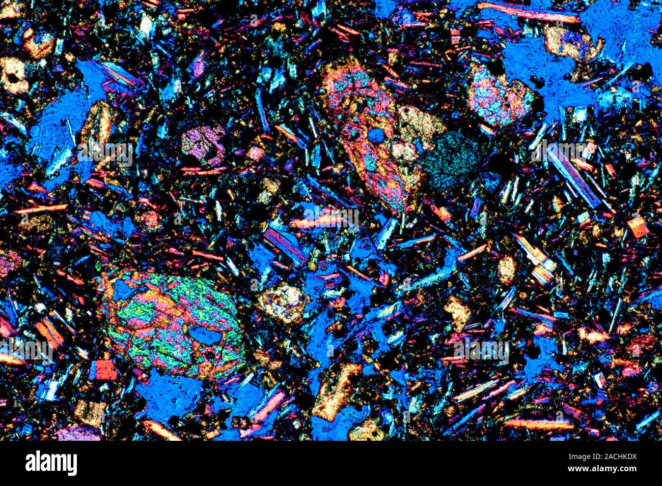 Polarised light micrograph of a thin section of basalt, an igneous rock ...