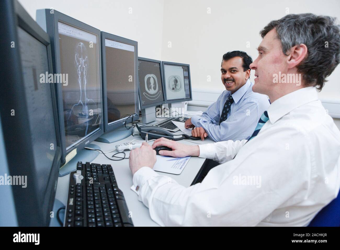 Pet CT scanner image analysis suite in use with medical staff ...
