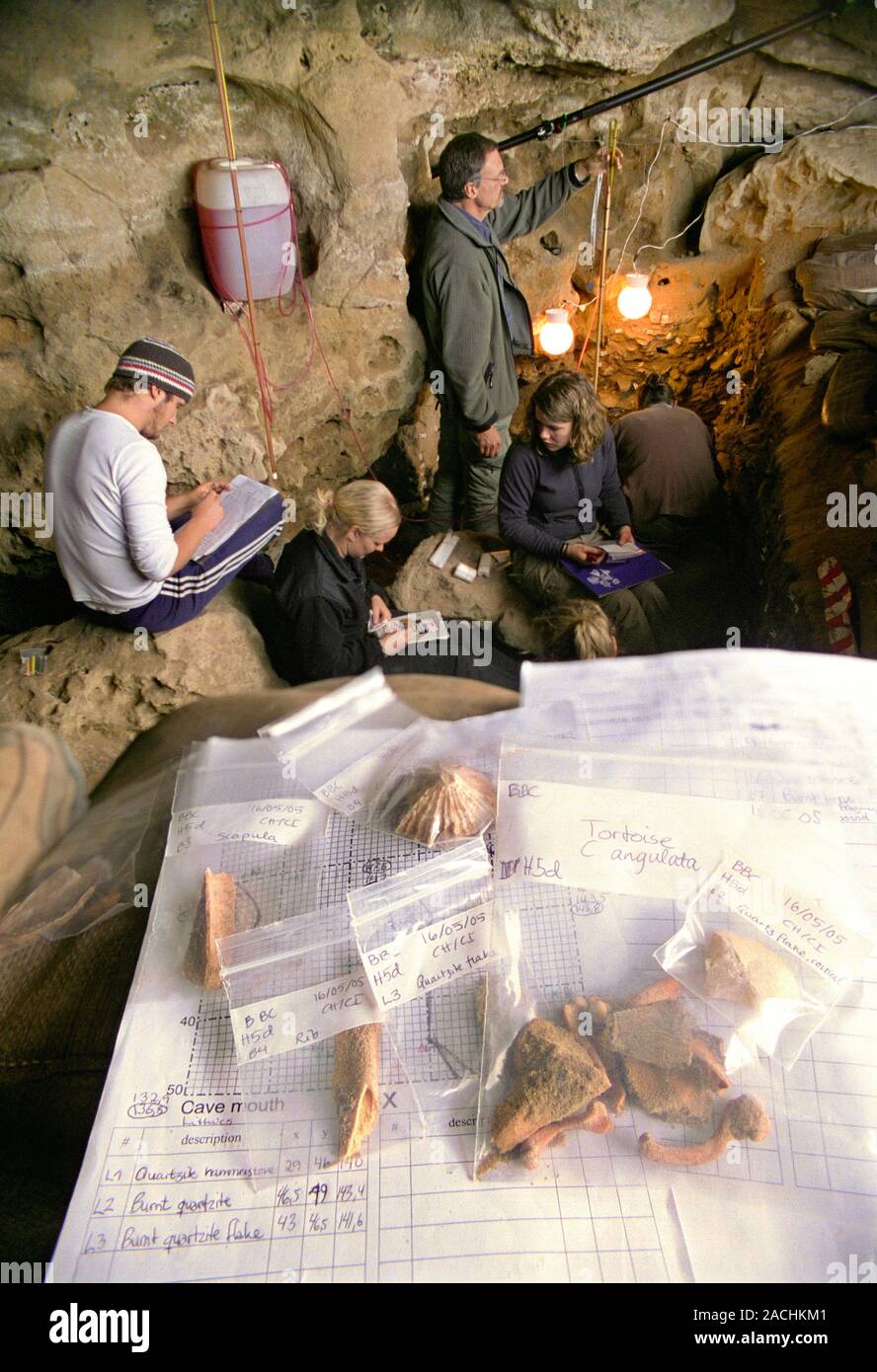 Archaeological excavation. Archaeologists recording data from the ...