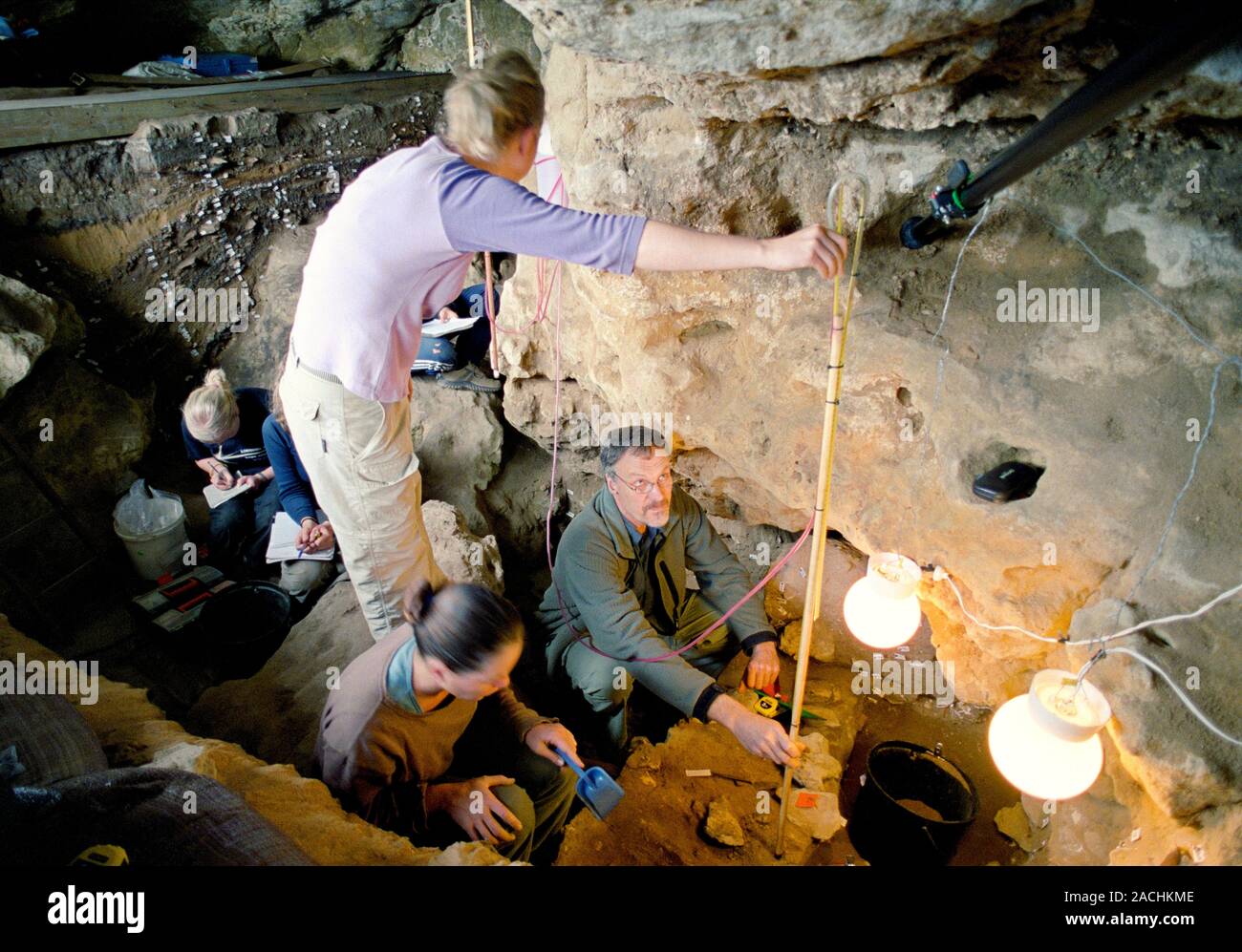 Archaeological excavation. Archaeologists checking the level and depth ...