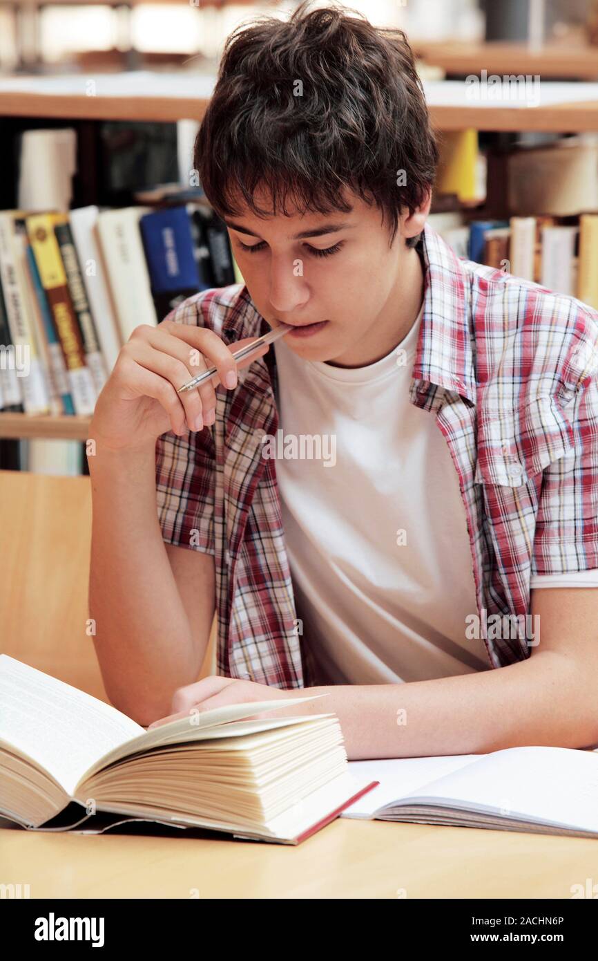 Library. Young man studying in a library Stock Photo - Alamy