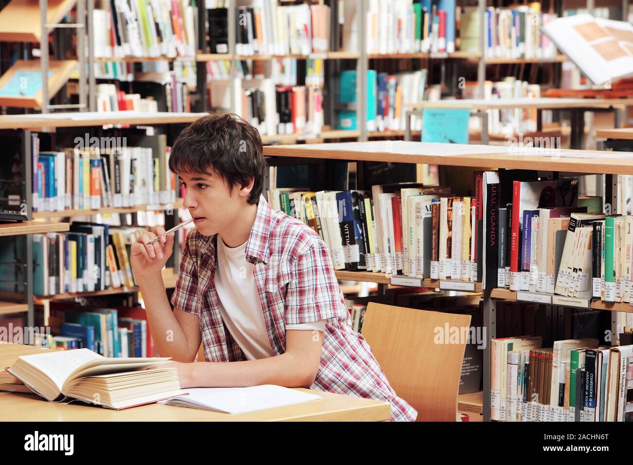 Library. Young man studying in a library Stock Photo - Alamy