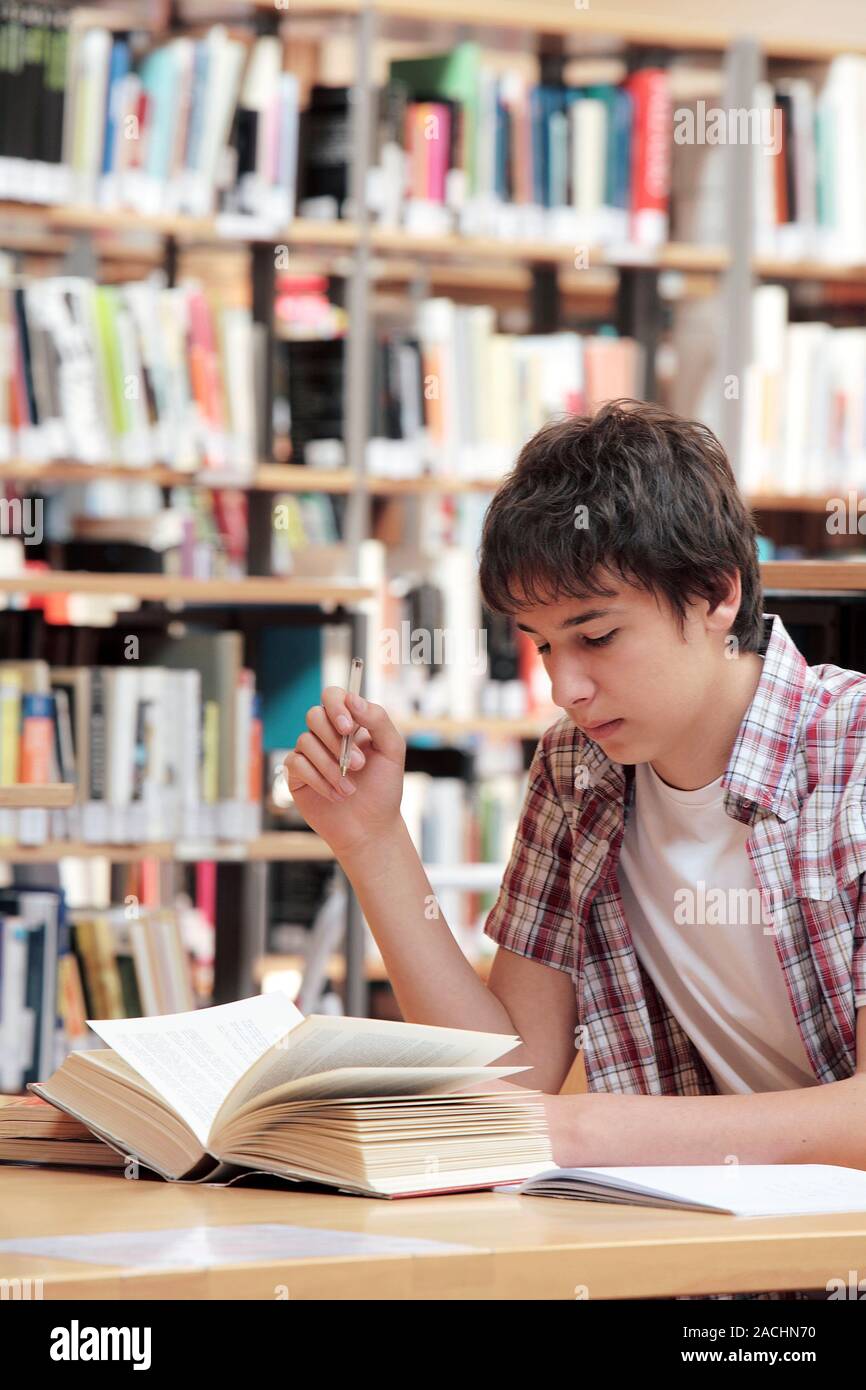 Library. Young man studying in a library Stock Photo - Alamy
