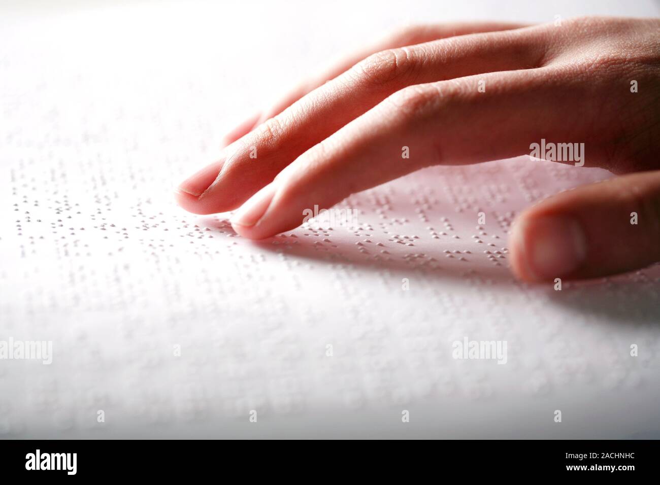 Braille reading. Hand of a blind person reading braille. The braille ...