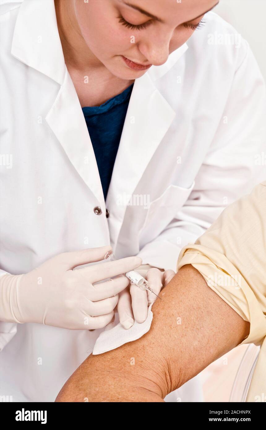 Geriatric care. Nurse giving an older man an injection Stock Photo - Alamy
