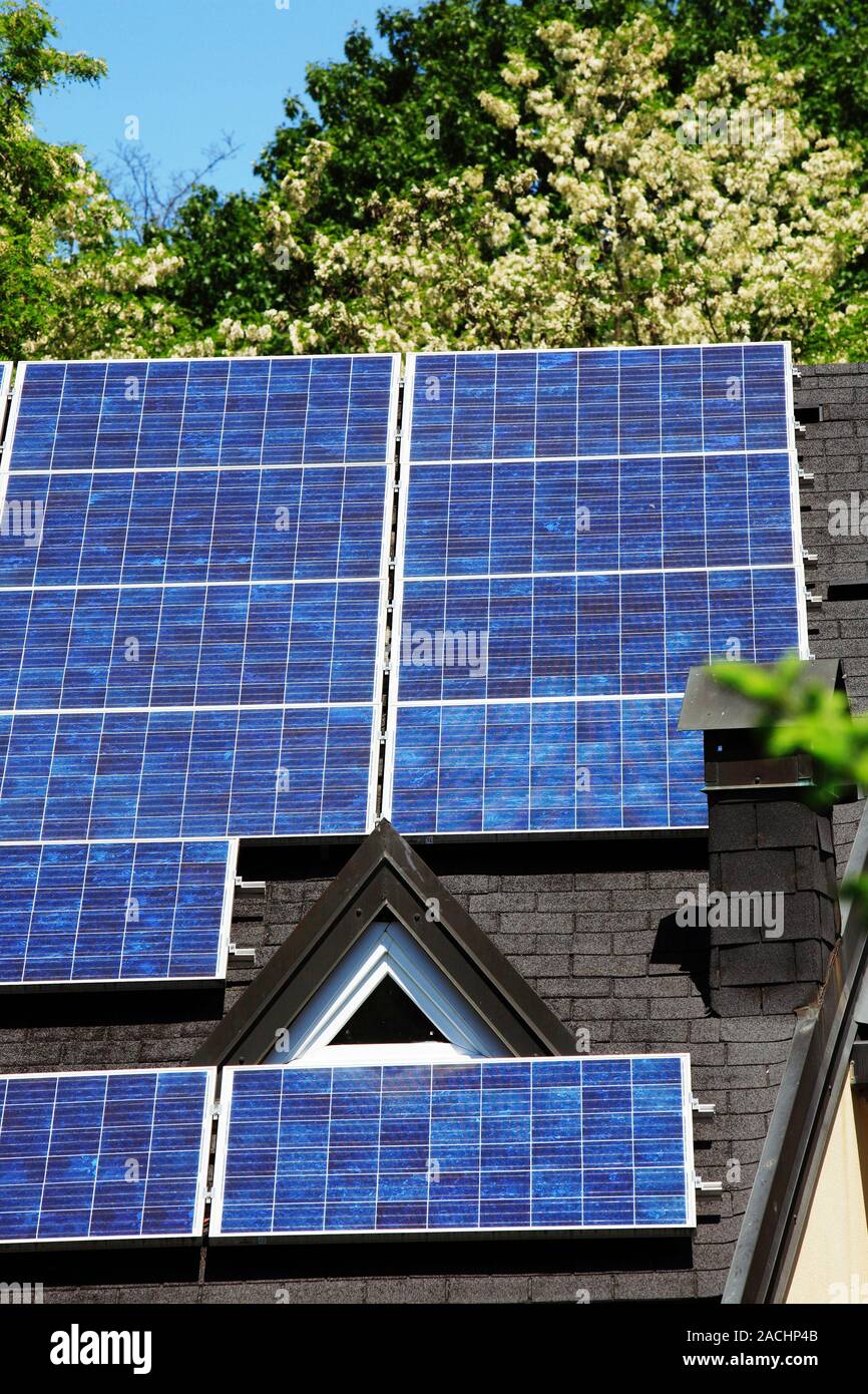 Rooftop solar panels. Arrays of photovoltaic cells on the roof of a ...