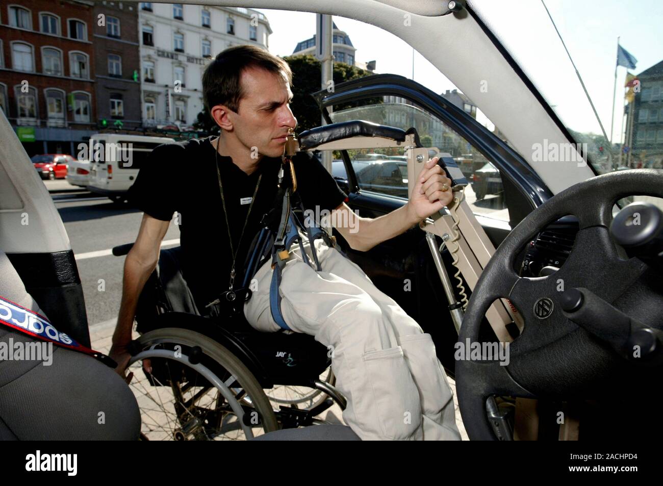 Wheelchair user getting into a specially adapted car Stock Photo - Alamy
