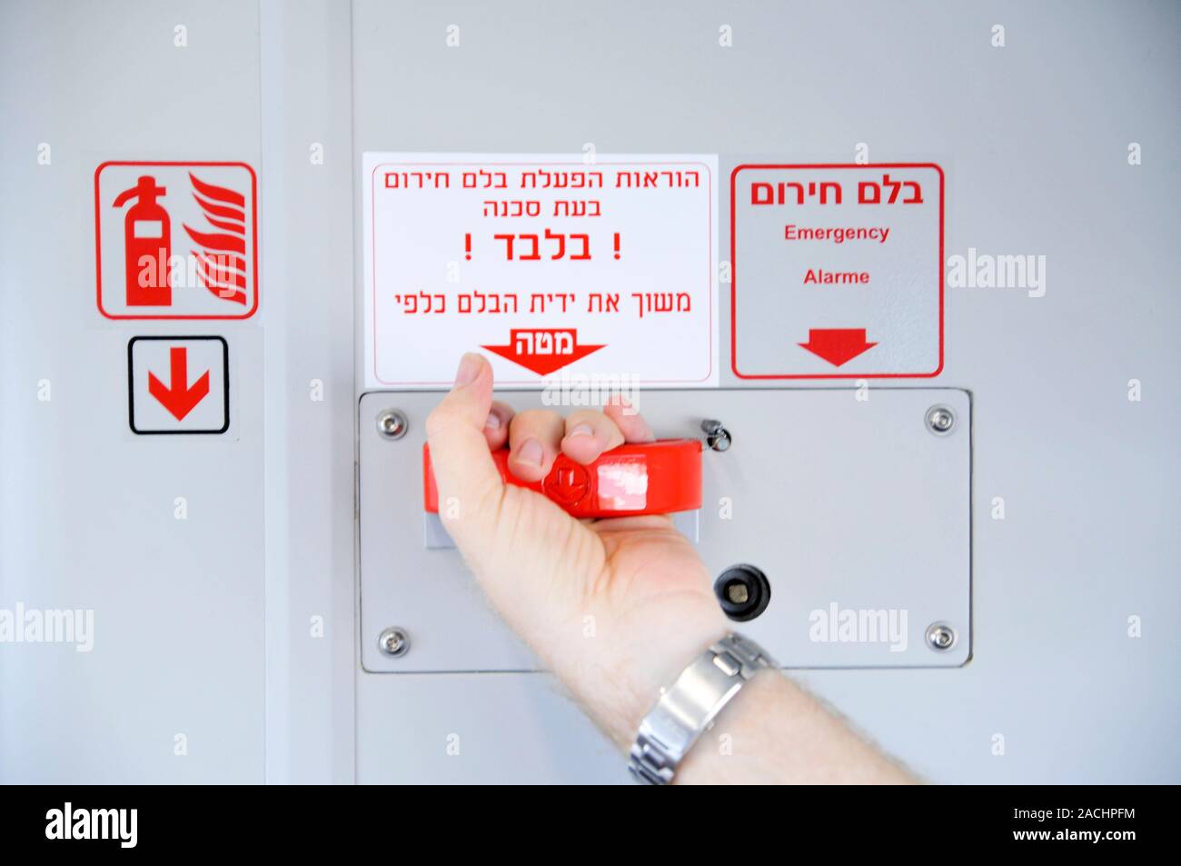 Passenger pulling the emergency brake in a train coach. Israel Stock ...