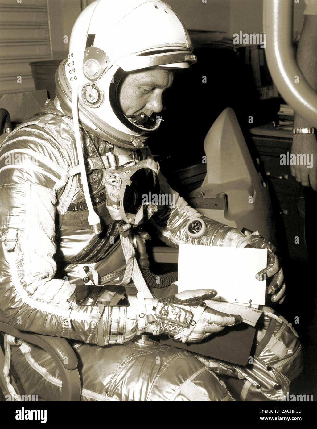 John Glenn (1921-2016), American astronaut studying his flight ...