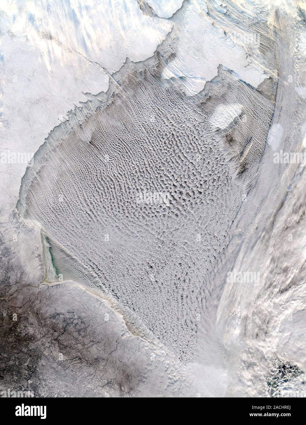 Coastal cloud streets. Satellite image of parallel lines of clouds ...