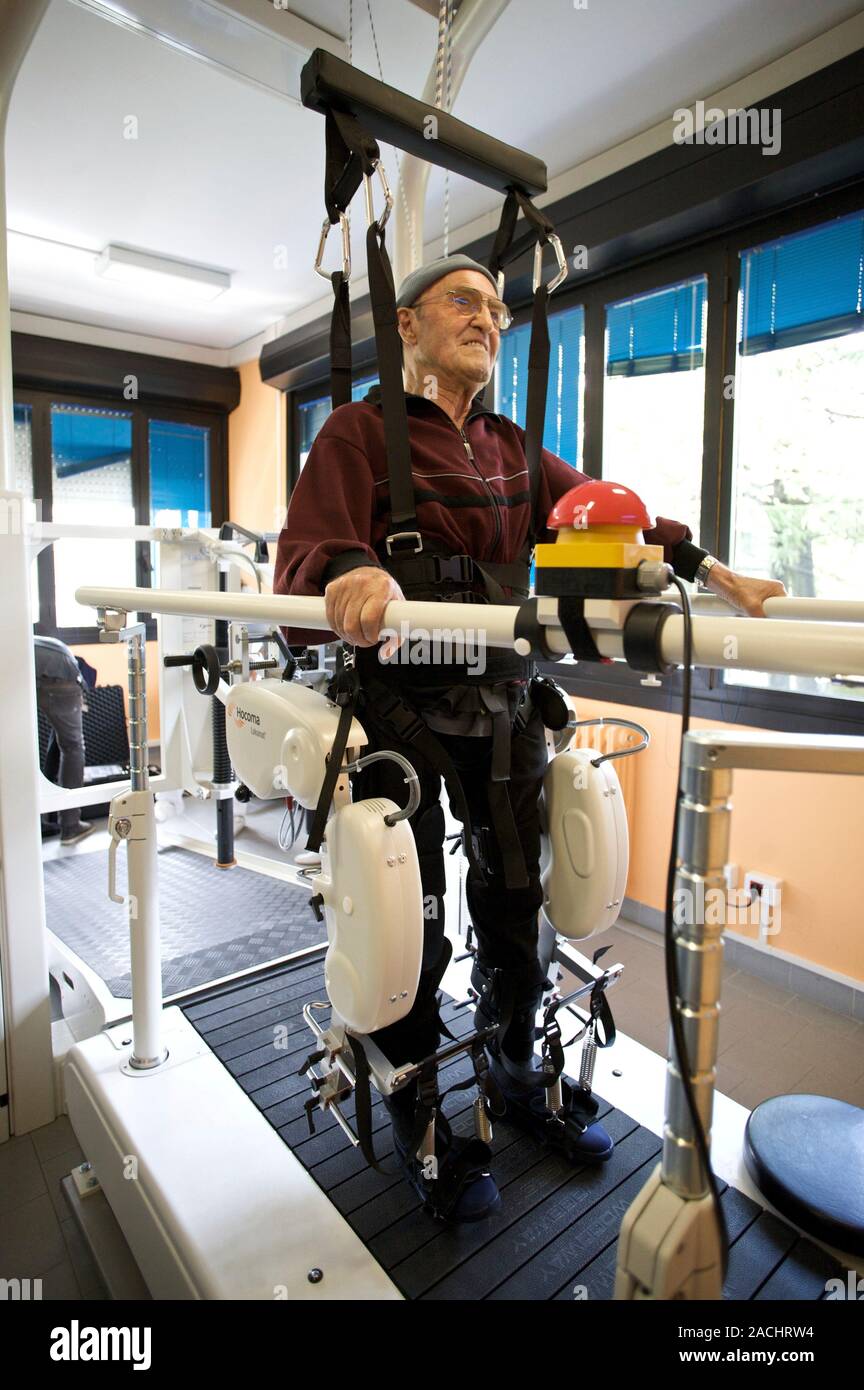 Lokomat walking therapy. Elderly patient on a treadmill, using the ...