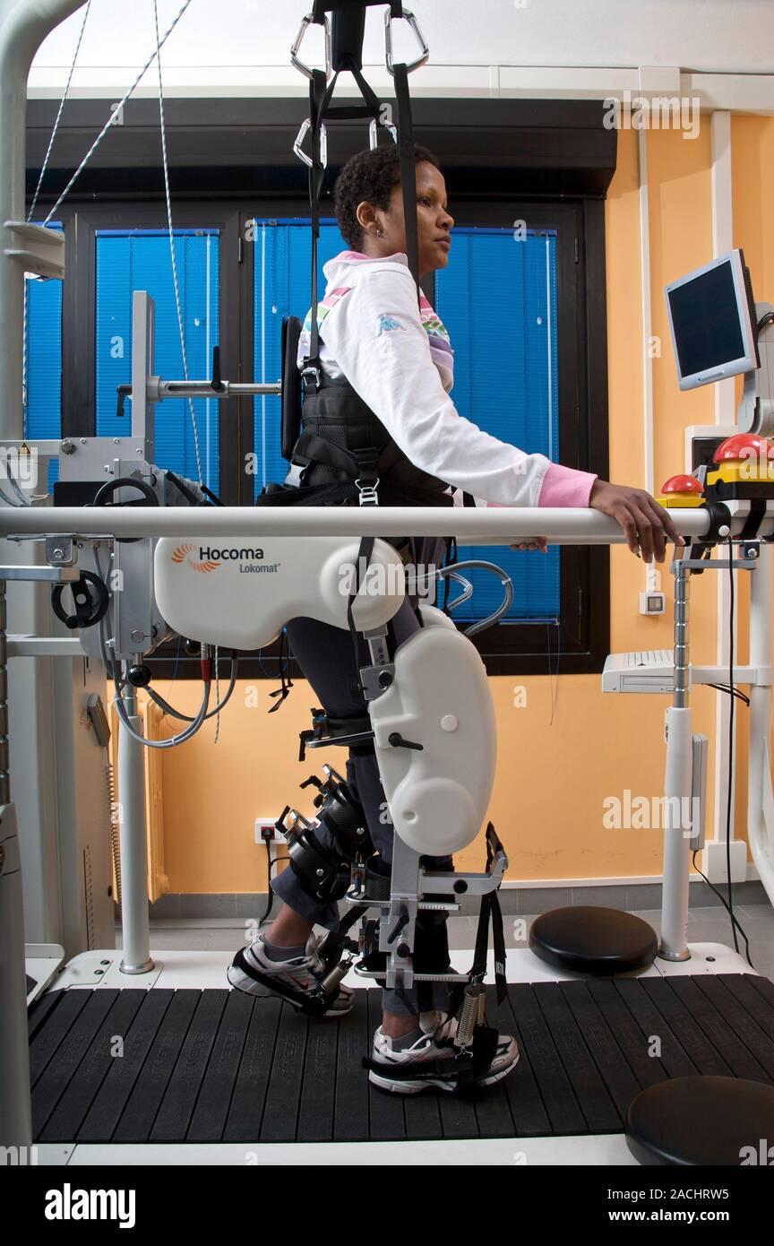 Lokomat walking therapy. Female patient on a treadmill, using the ...