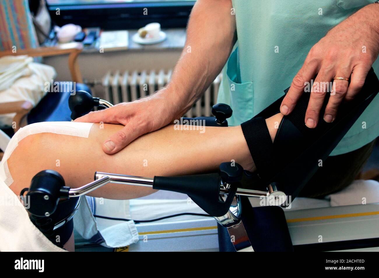 Physical therapy machine. Physical therapist helping a female patient ...