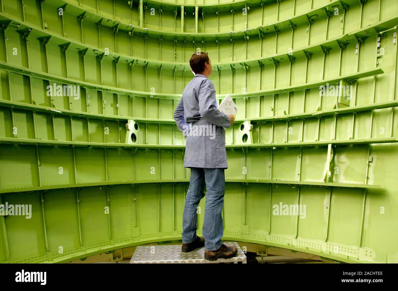 Aerospace engineering. Worker inspecting a structure being built in an ...