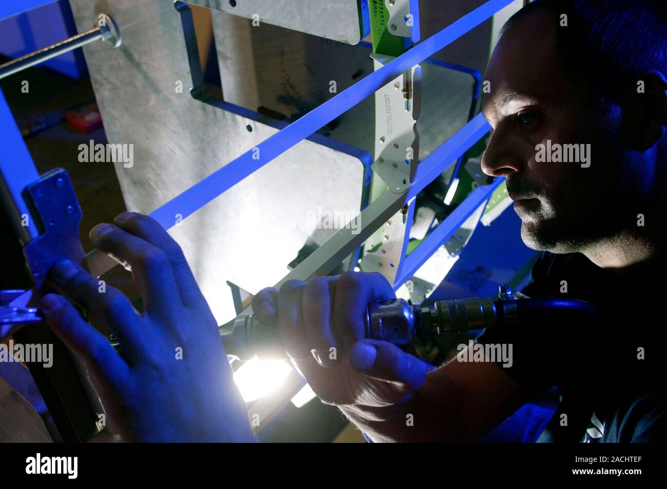 Aerospace engineering. Worker in an aerospace factory. This is the ...
