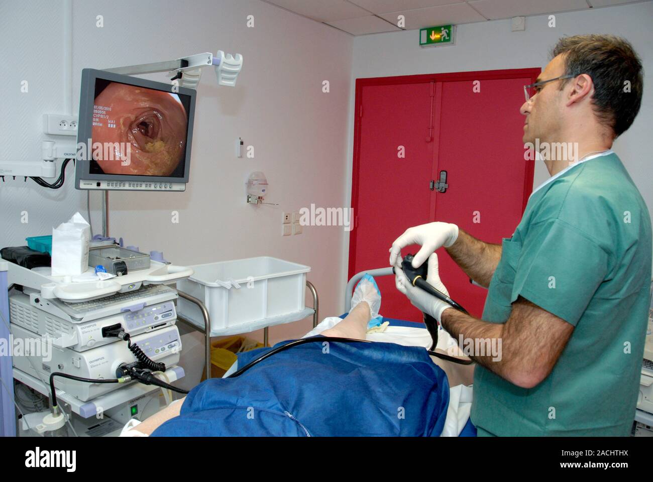 Colonoscopy examination. Doctor performing a colonoscopy on a patient ...
