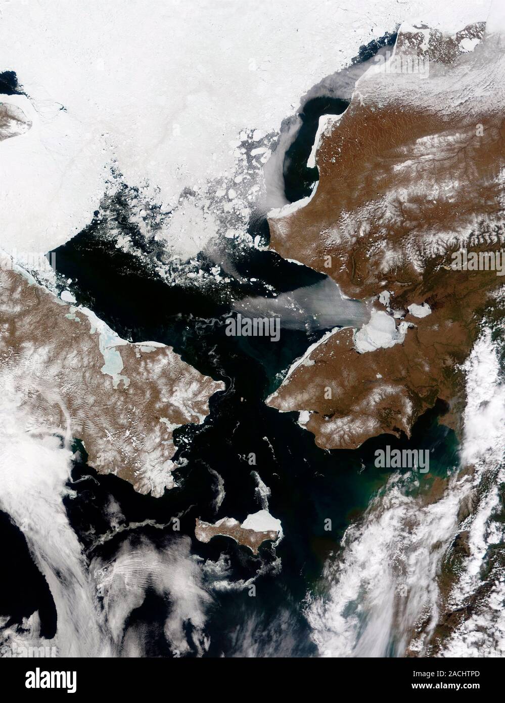 Bering Strait, satellite image. North is at top. Clouds, snow and ice ...