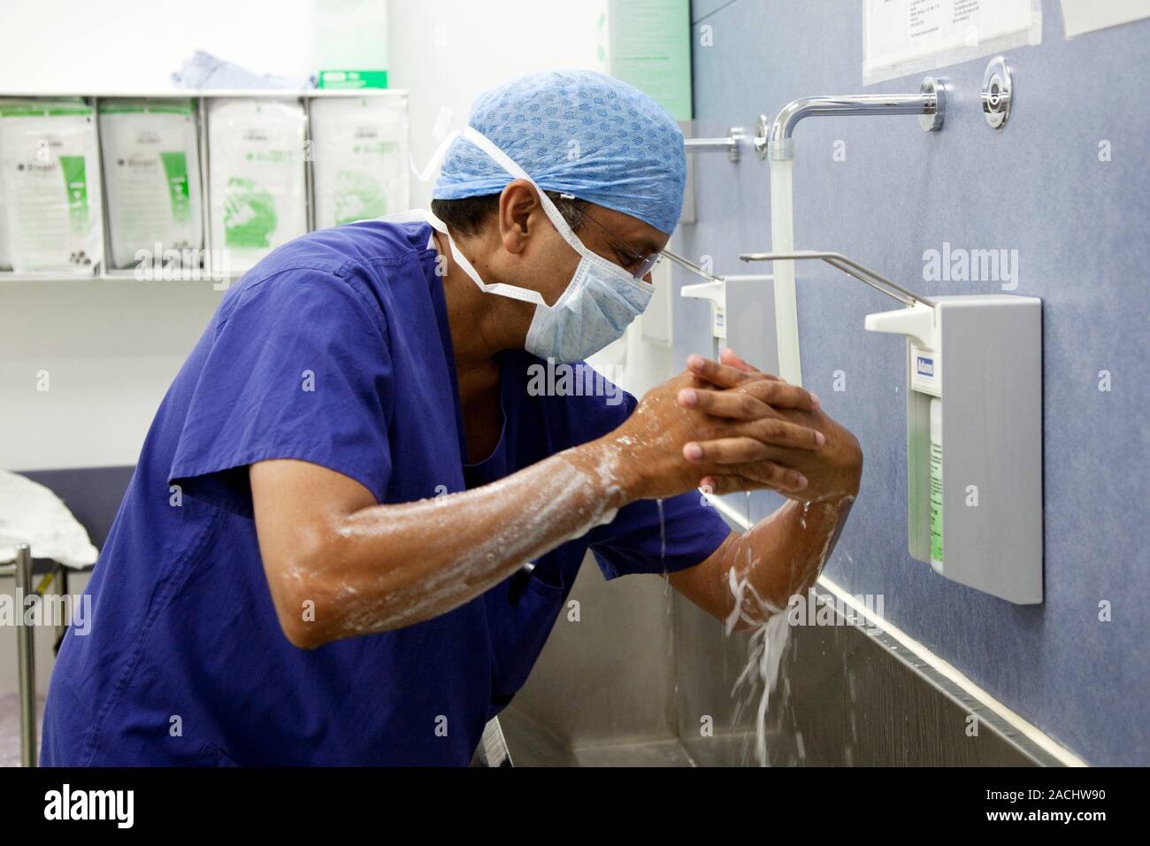 Scrubbing up. Surgeon cleaning his hands before surgery. Cleanliness in ...
