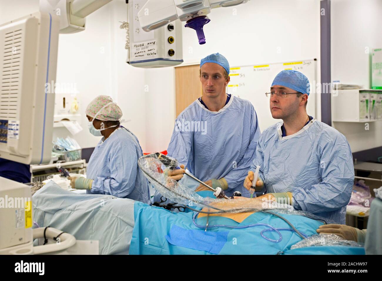 Hernia surgery. Surgeons performing a laparascopic (keyhole) repair of ...