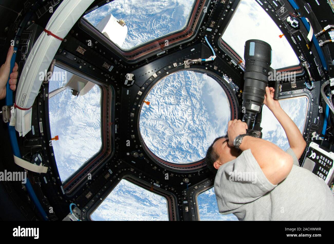 Astronaut photographing aboard the ISS. Astronaut taking photographs of ...