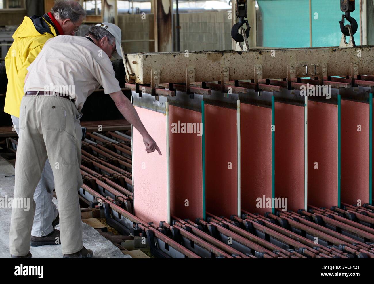 Electrolysis in copper ore processing. Visitors examining copper plates ...