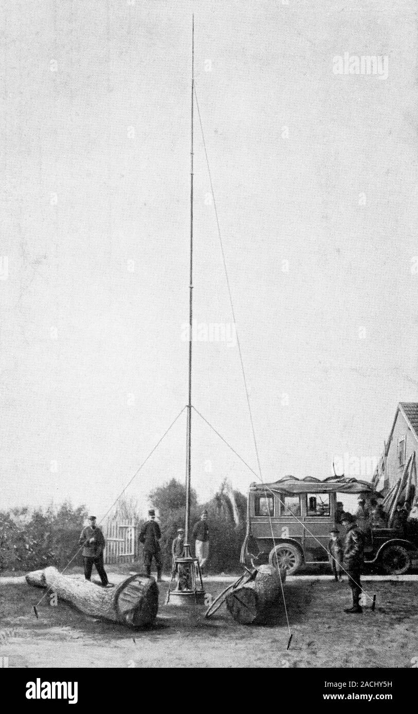 Telescopic portable radio mast. The mast, held up by guy ropes anchored ...