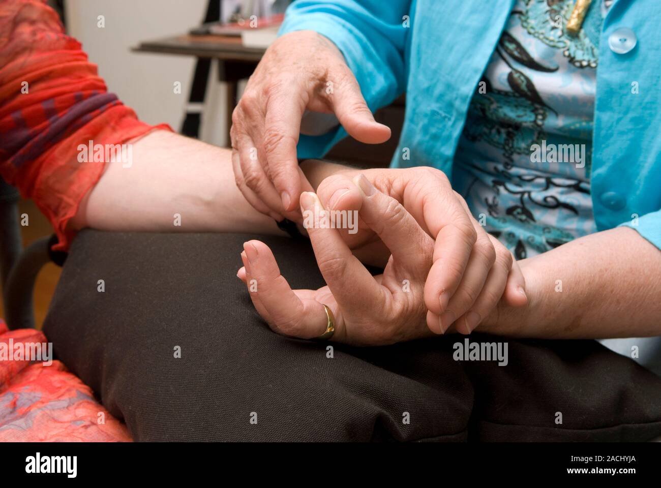 Metamorphic massage. Therapist working on a patient's wrist using ...