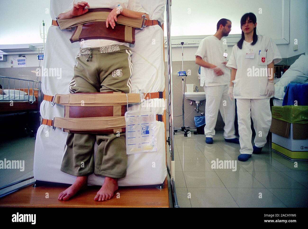 Rehabilitation for coma patient. This patient has been stood upright ...