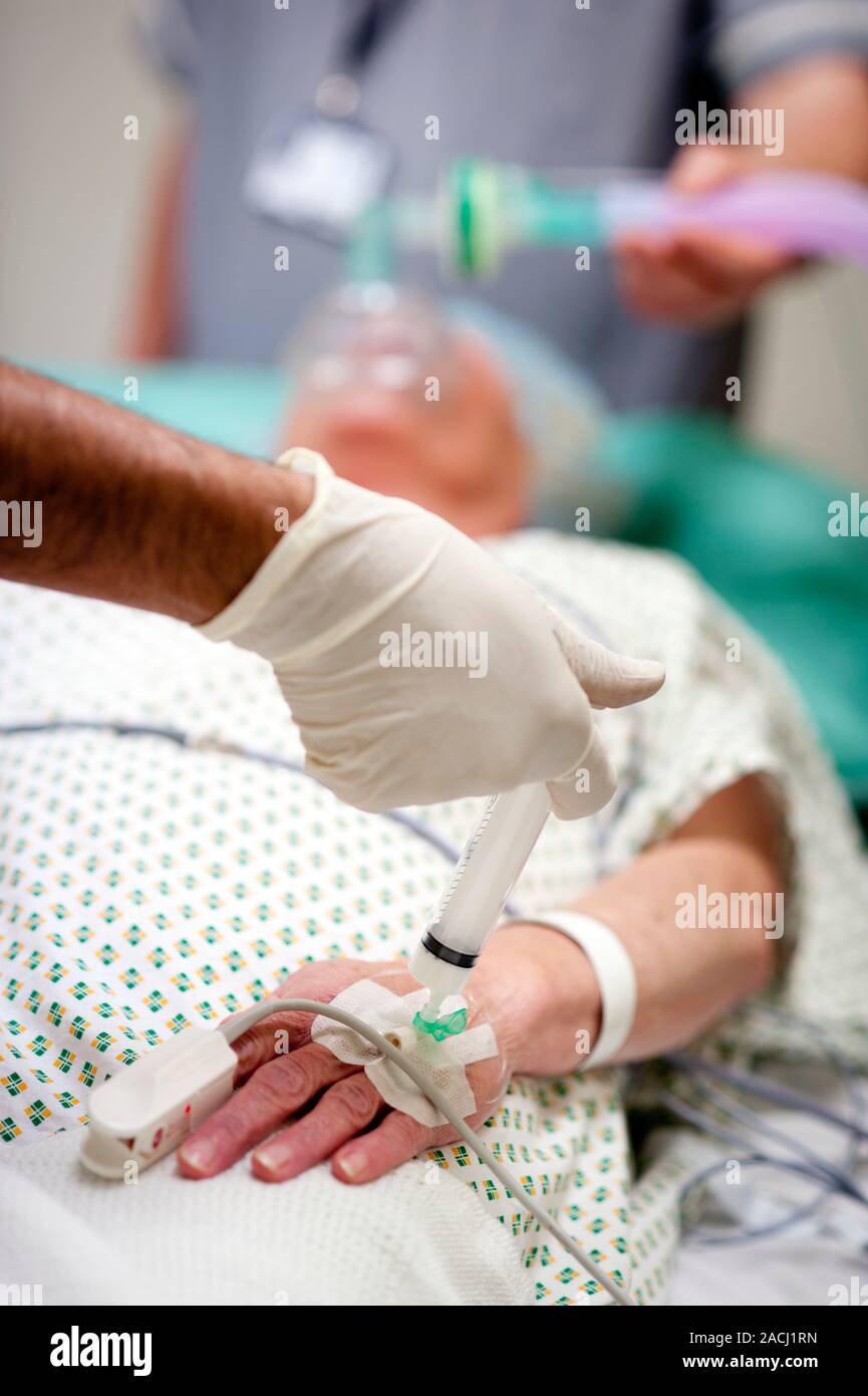 Anaesthestic injection. Anaesthetist injecting a patient with an ...
