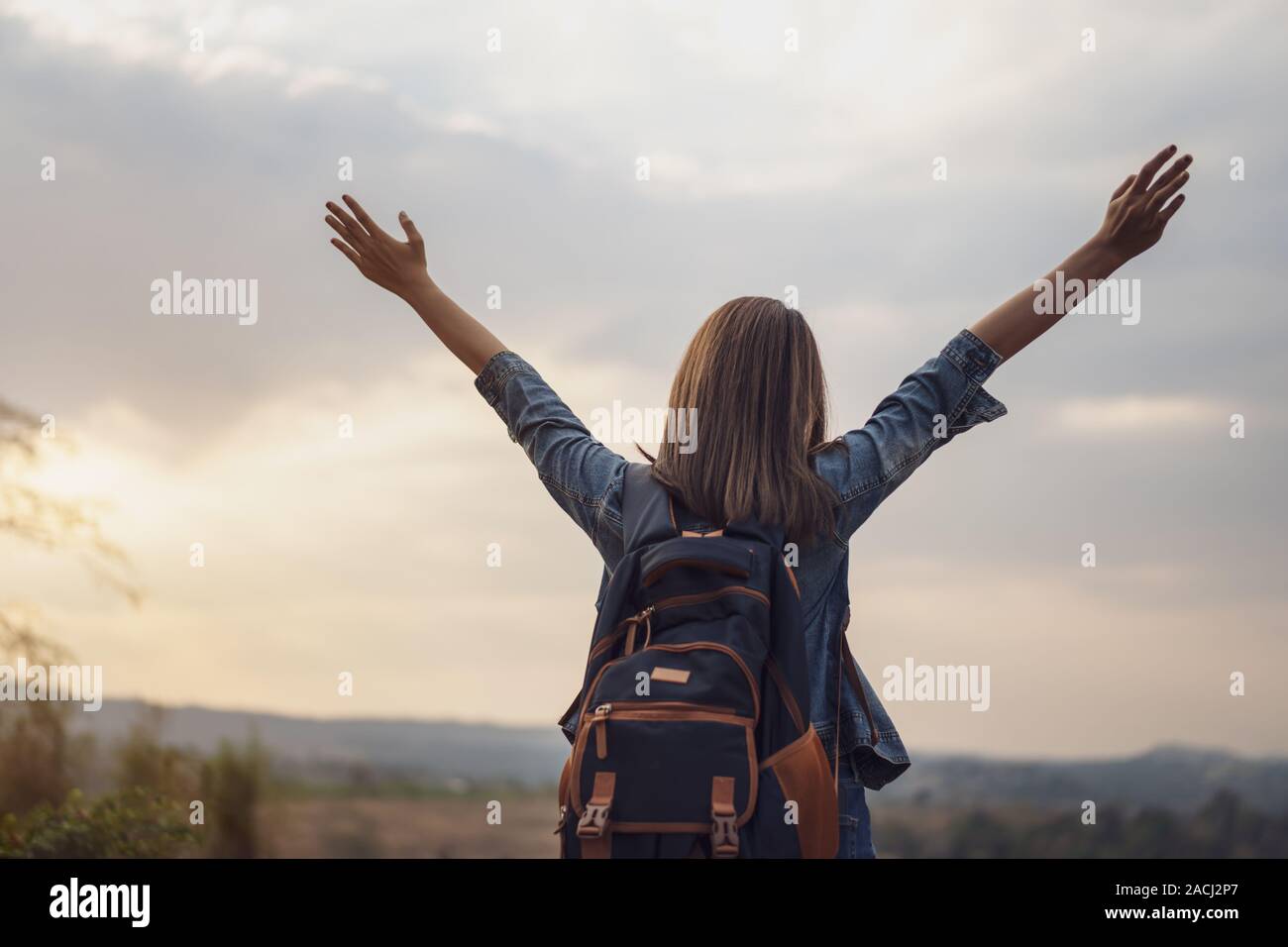Woman arms raised rear view sky hi-res stock photography and images - Alamy