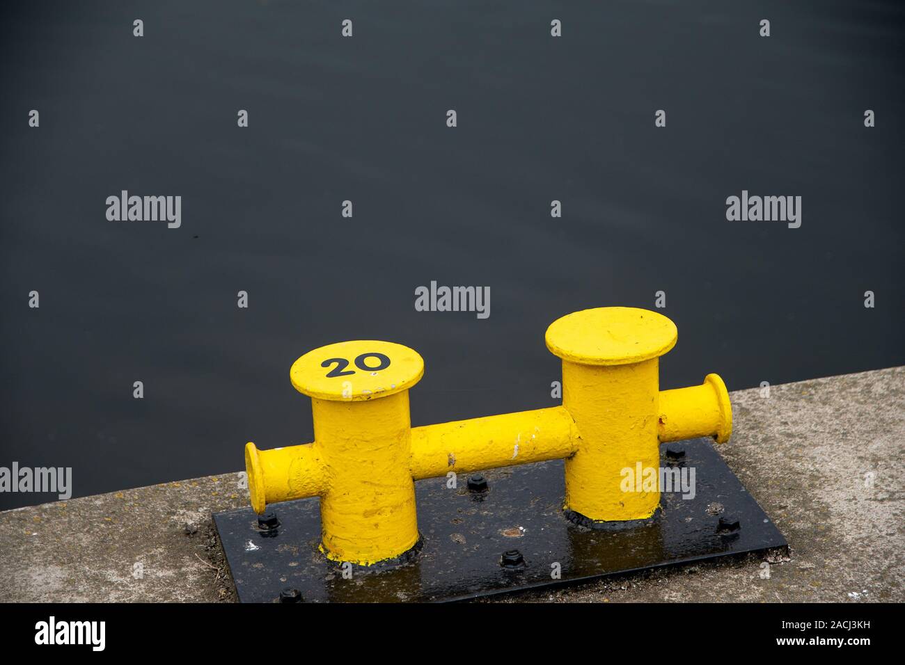 Two yellow mooring post at the harbor or marina port Stock Photo - Alamy