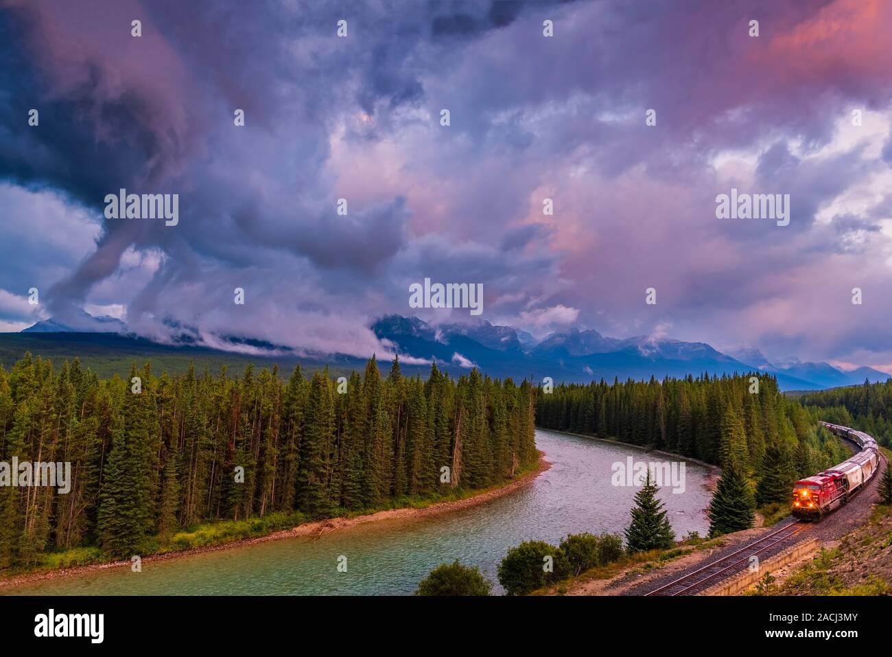 Canadian Pacific Train Coming Out of a Curve with Storm Clouds, Banff National Park, Alberta ...