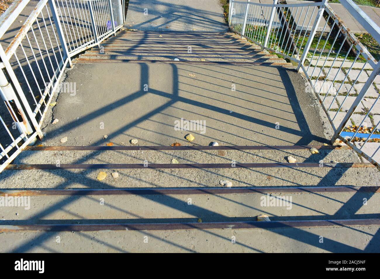 Gray reinforced concrete steps when descending from the bridge ...