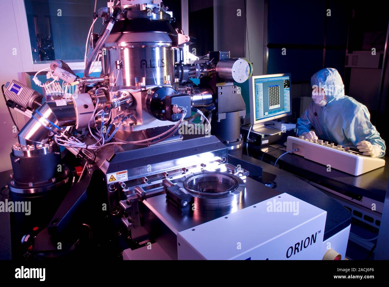 Helium ion microscope. Researcher operating a helium ion microscope, a ...