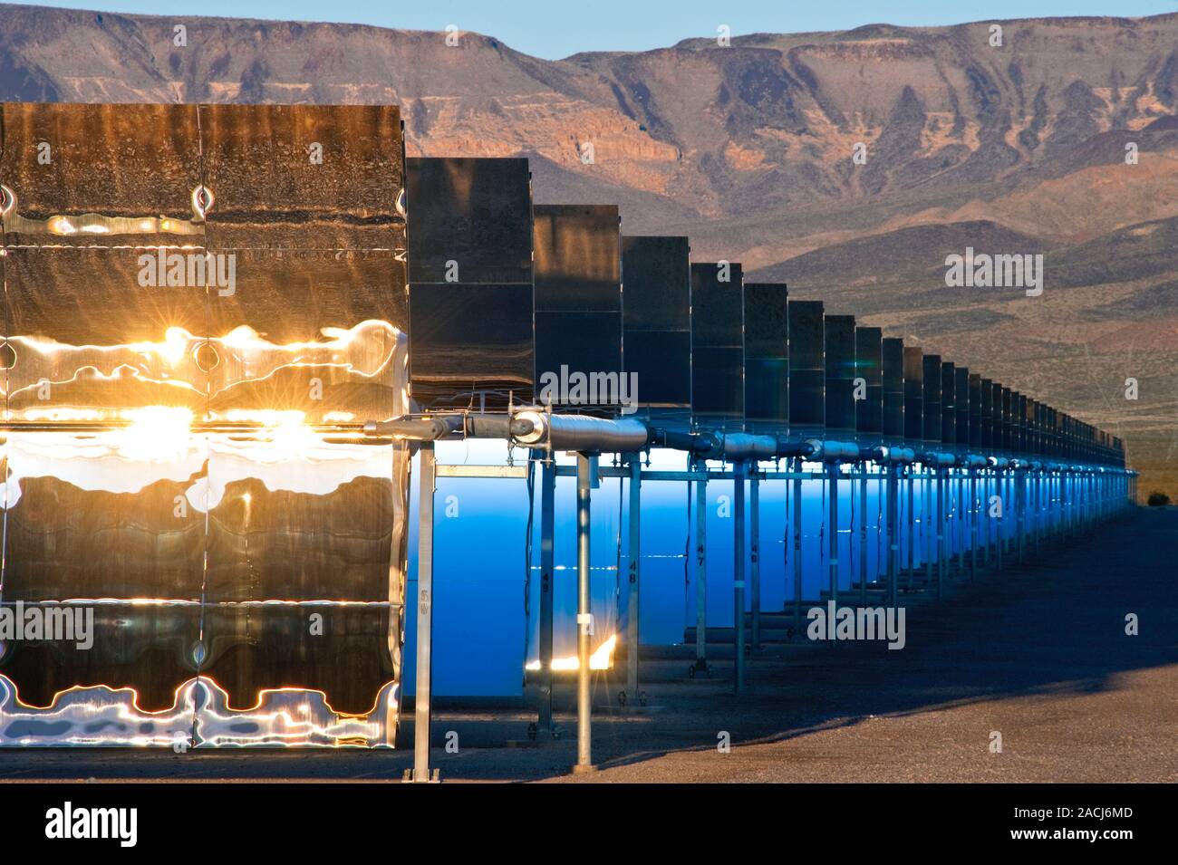 Solar power plant at sunrise. Parabolic mirrors at a solar power plant ...