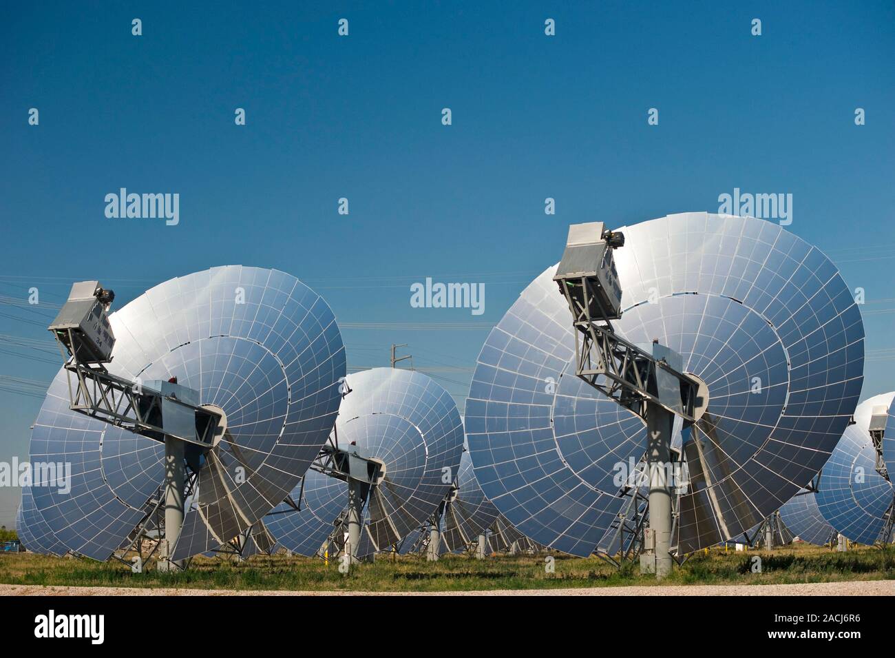 Concentrating solar power plant. Array of heliostats (mirrors with sun ...