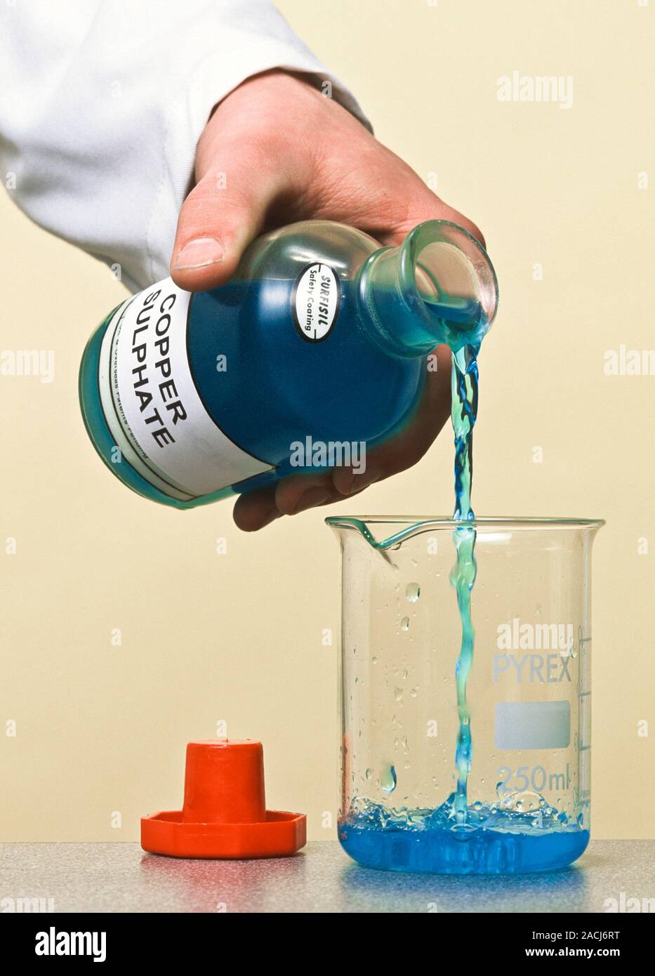 Copper sulphate solution. Chemistry student pouring sopper sulphate ...