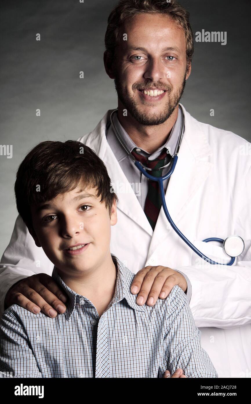 Paediatrics. Doctor standing behind a boy Stock Photo - Alamy