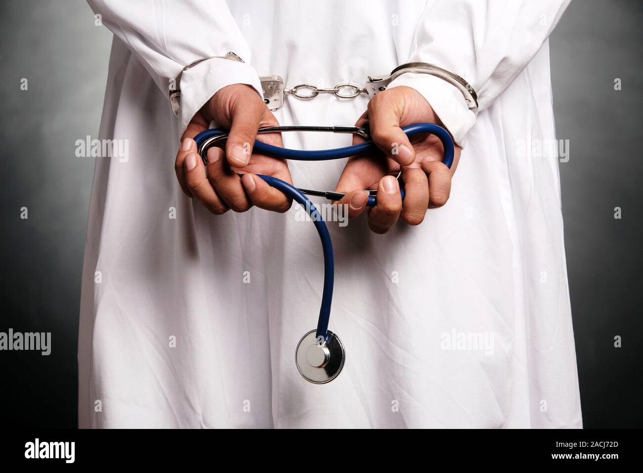Medical malpractice, conceptual image. Doctor in handcuffs representing ...