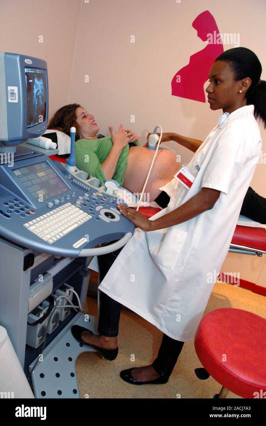 Pregnancy ultrasound scan. Hospital doctor using an ultrasound ...